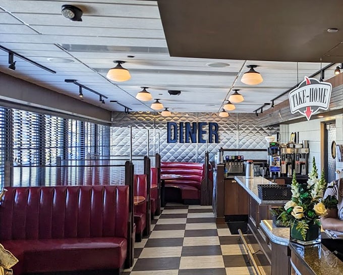 Classic red booths, checkered floors, and that diamond-patterned wall—this isn't your grandfather's diner, but he'd still feel right at home.