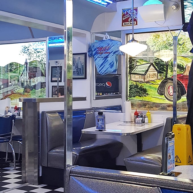 Classic vinyl booths and checkerboard floors—sitting here feels like you've wandered onto the set of a nostalgic movie where calories don't count.