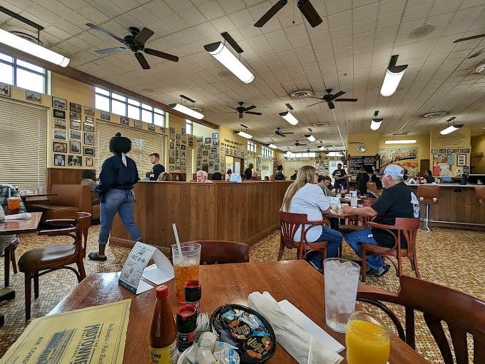 Inside, the bustling dining room hums with conversation and clinking silverware—the universal symphony of a beloved local eatery where calories don't count before noon.