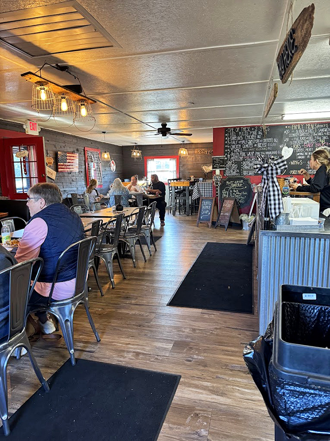 Inside, the rustic charm hits you like a warm hug – wooden walls, metal chairs, and that magnificent chalkboard menu promising smoky treasures to come.