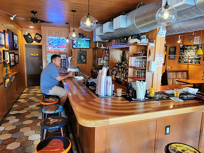 Inside, the wood-paneled walls and hexagonal floor tiles tell stories of countless seafood feasts. The bar's worn wooden surface has supported more elbows than a therapist's couch.