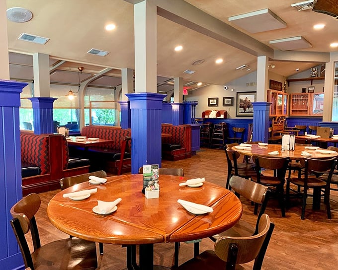 Blue pillars and red booths create a maritime-meets-mountain vibe where comfort reigns supreme and conversations flow as smoothly as the nearby lake.