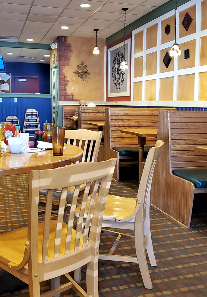 Cozy wooden booths and warm yellow walls create that perfect diner atmosphere—where conversations flow as freely as the coffee refills.