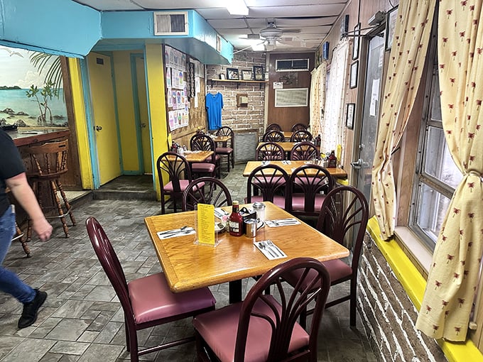 Step inside and you're transported to old Florida charm—turquoise walls, cozy tables, and curtains that have witnessed countless vacation stories and local gossip.