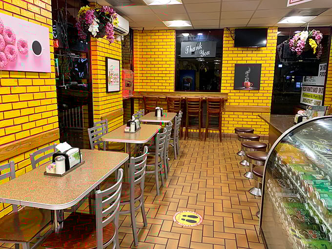 Yellow brick walls and no-nonsense tables create the perfect backdrop for serious donut contemplation. Simplicity at its sweetest.