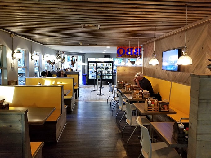 Cozy yellow booths and wood-paneled walls create the perfect backdrop for serious barbecue business. No distractions here – just you and your imminent food happiness.