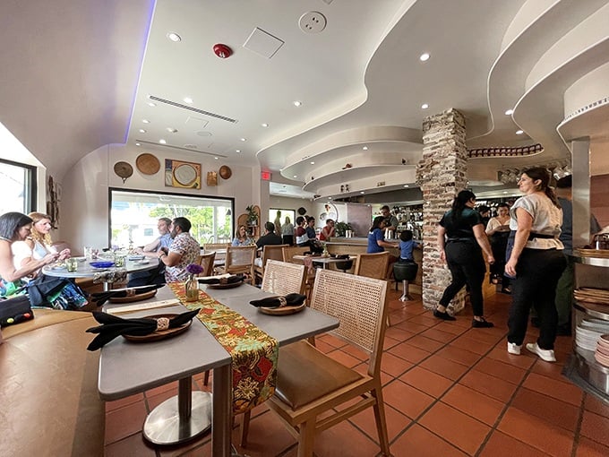 "Inside Kaya, tradition meets modern design with curved ceilings, terra cotta floors, and woven chairs that whisper, 'Stay awhile, there's more to taste.'"