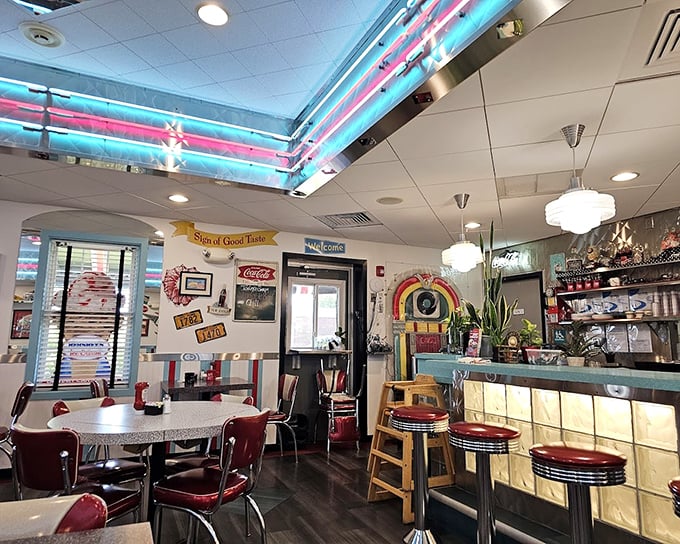 Neon dreams and chrome gleams—the interior's aqua and red color scheme hits that perfect sweet spot between authentic and Instagram-worthy.