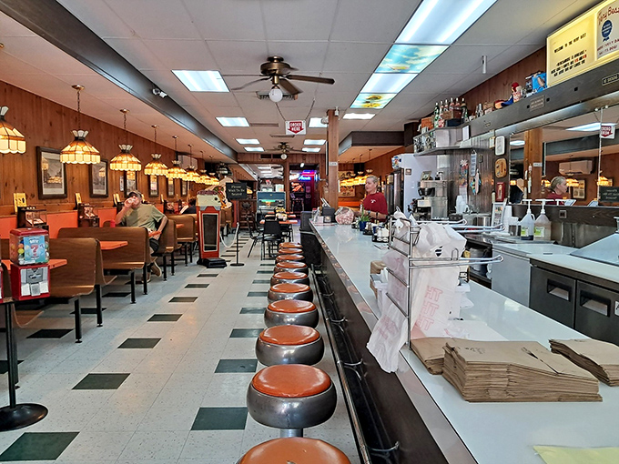 Classic diner seating with those swivel stools that make everyone feel like a kid again. The checkerboard floor has witnessed decades of satisfied customers.