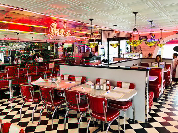 Classic red vinyl booths, checkerboard floors, and neon lighting – this isn't just a diner, it's a time machine with table service.