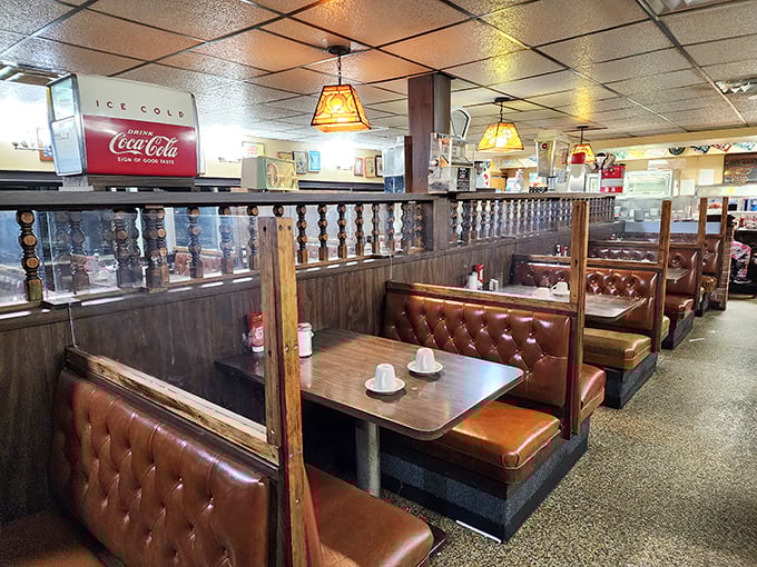 Classic diner perfection: tufted vinyl booths, wood paneling, and pendant lights creating the kind of nostalgic atmosphere where calories simply don't count.