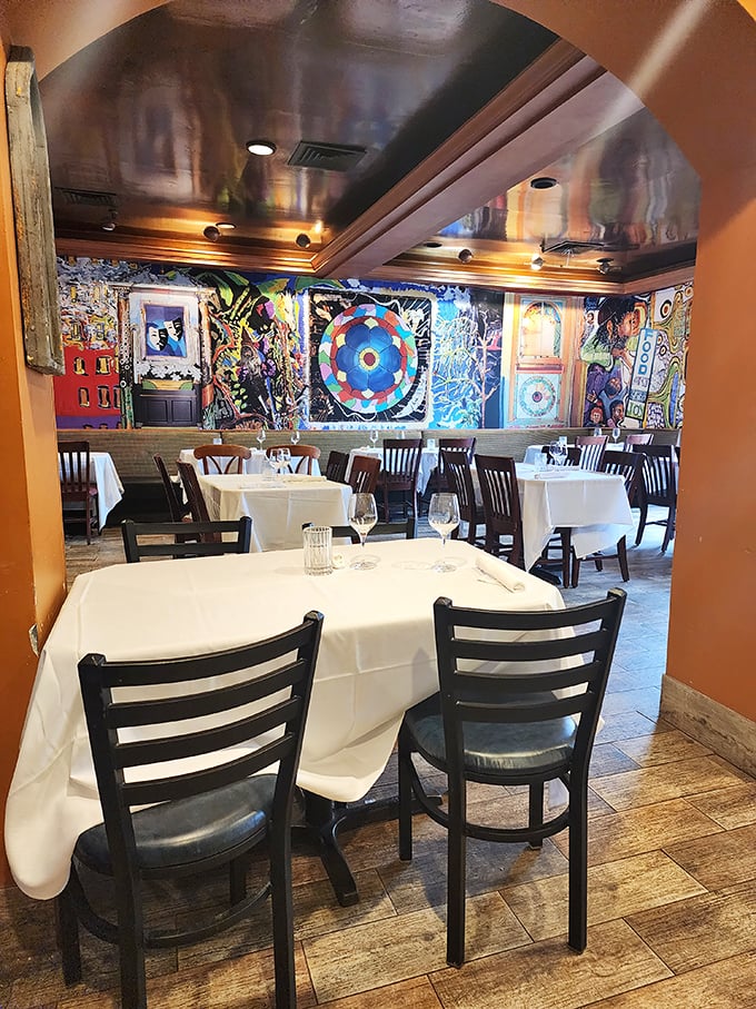 Where fine dining meets artistic explosion. Those vibrant wall murals aren't just decoration – they're a preview of the colorful flavors waiting at your table.