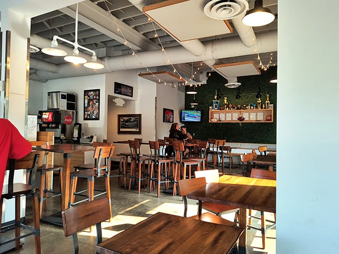 Industrial-chic meets comfort in this no-frills dining space. The exposed ceiling and string lights say, "We saved our energy for the chicken."