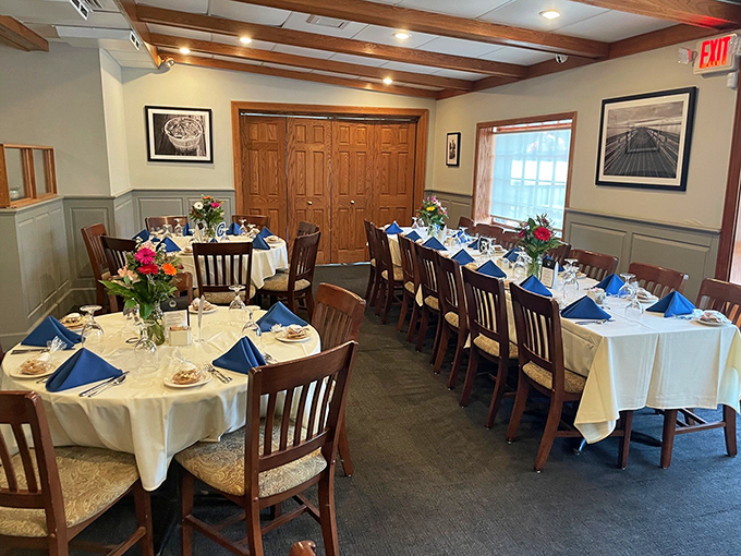 White tablecloths, wooden chairs, and fresh flowers create that perfect balance of elegance and comfort—like dining at a sophisticated friend's country home.