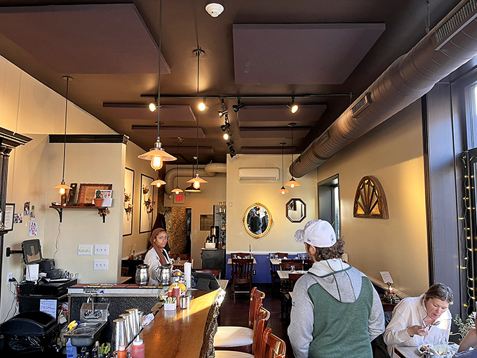 Inside, pendant lighting casts a warm glow over wooden tables while exposed ductwork keeps things refreshingly unpretentious – breakfast without the air of self-importance.