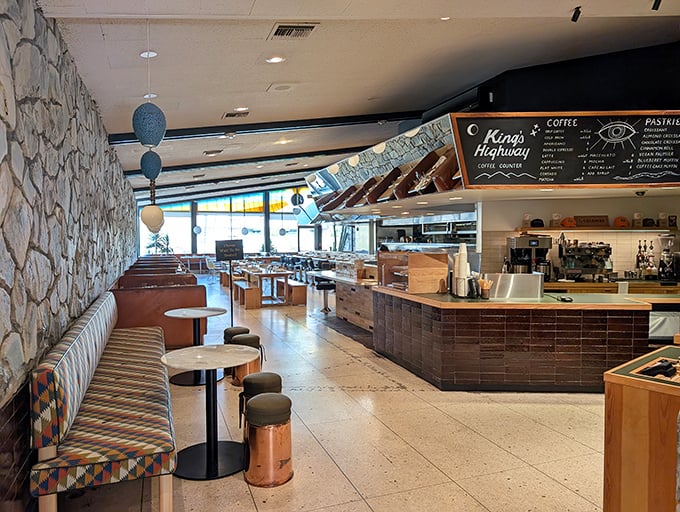 The interior blends roadside Americana with desert chic – terrazzo floors, stone walls, and colorful banquettes that say "stay awhile" in the universal language of comfort.