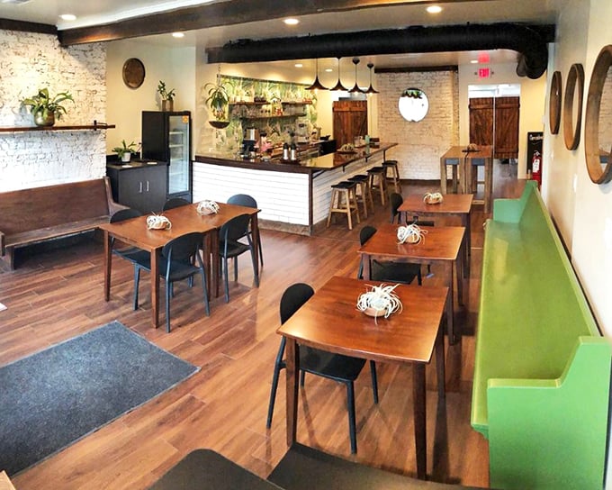Exposed brick walls meet wooden beams in this cozy interior that somehow manages to feel both rustic and modern—like a hug from your coolest friend.