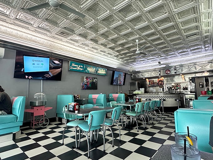 Step inside and witness turquoise vinyl booths meeting checkered floors in perfect 1950s harmony.