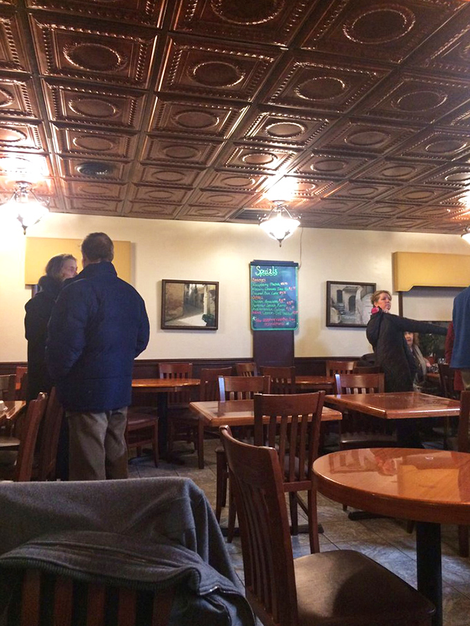 That ornate tin ceiling isn't just gorgeous décor—it's collecting the satisfied sighs of diners who've just tasted their first spoonful of cream of crab soup.