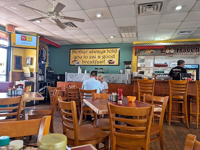 "Mother always told you to eat a good breakfast!" The sign speaks truth – this cozy interior with wooden chairs has witnessed countless morning revelations.