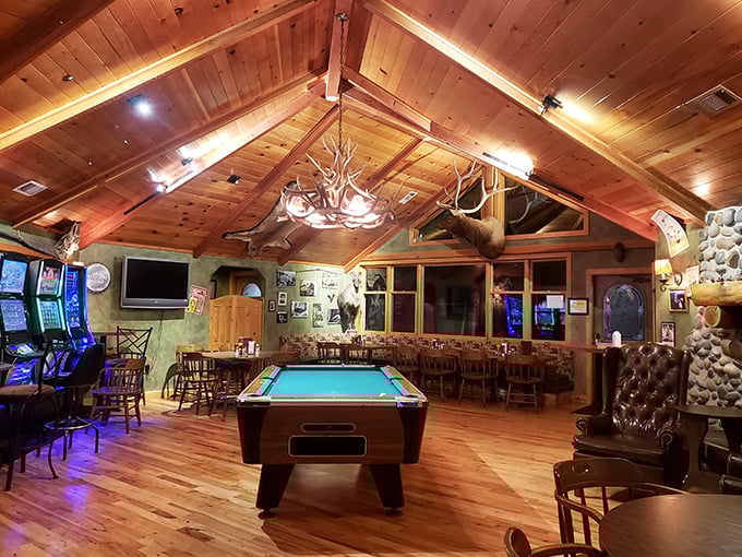 Rustic elegance meets game night vibes. Those antler chandeliers aren't just for show—they're keeping watch over serious pool tournaments and hearty appetites.