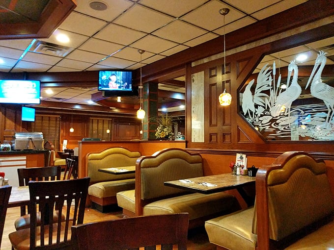 Wood paneling, pendant lights, and those impossibly comfortable booths – the holy trinity of proper diner design. Even the etched glass birds seem to say "stay awhile."