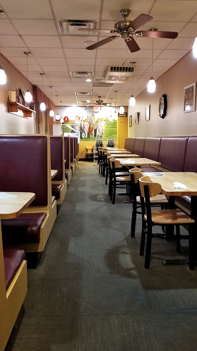 Classic burgundy booths and pendant lighting create that perfect diner atmosphere—where calories don't count and coffee refills are a human right.