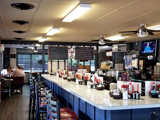 The classic diner counter beckons with its blue-and-cream color scheme – a front-row seat to the breakfast theater that unfolds daily.