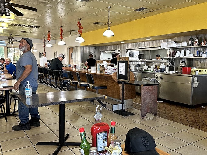 Inside, the sunny yellow walls mirror the golden yolks that have made this place famous. The open kitchen design lets you witness the breakfast ballet in action. 