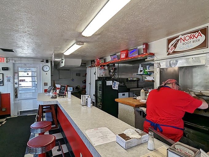 No fancy digital displays or celebrity chef endorsements here—just a counter, stools, and the promise of burger perfection.