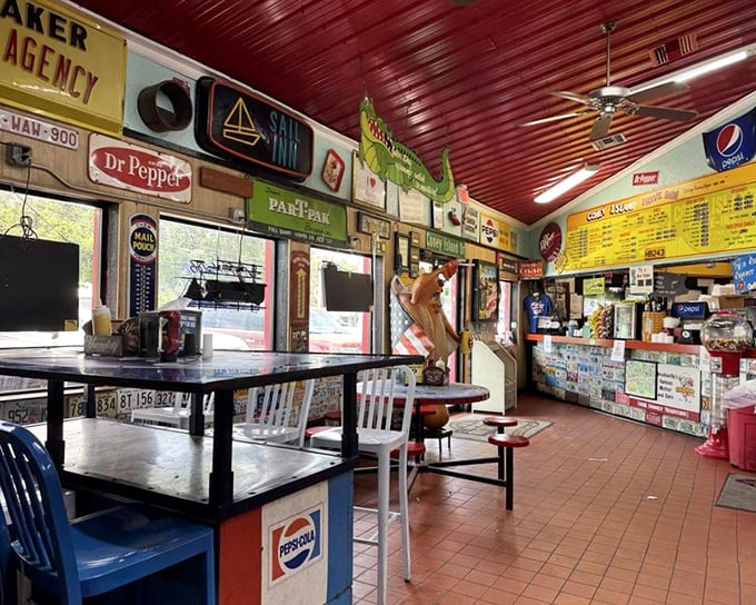 Step inside and you're transported to a simpler time – vintage signs, red ceiling, and picnic tables create the perfect backdrop for hot dog bliss.