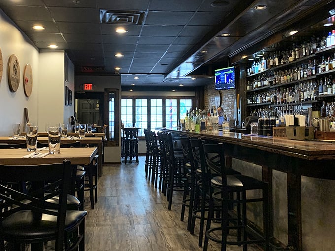 Inside, exposed brick meets polished wood in a space that feels both rustic and refined—like your coolest friend's apartment, if that friend happened to be a burger genius.