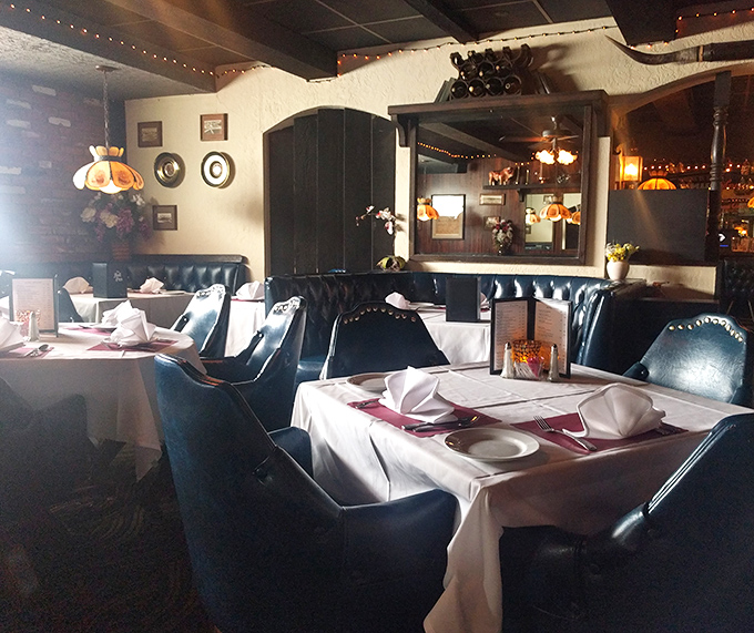 Deep leather booths, white tablecloths, and Tiffany-style lamps create the perfect steakhouse ambiance. This isn't décor—it's a commitment to dining tradition.