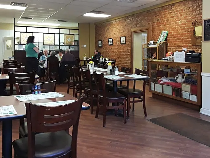 Inside, exposed brick walls and wooden chairs create that perfect "everybody knows your name" atmosphere where comfort food and conversation flow freely.
