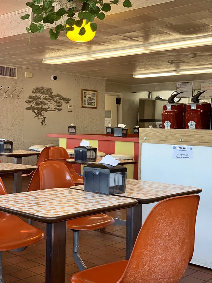 Step back in time with orange molded chairs and vintage tabletops. This isn't retro by design—it's authentic because it never changed.