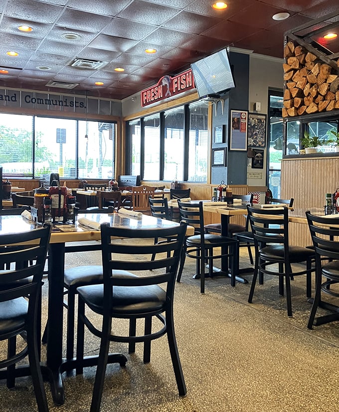 Inside, the dining room balances no-nonsense functionality with genuine character—note the firewood stack, a not-so-subtle hint about their cooking methods.