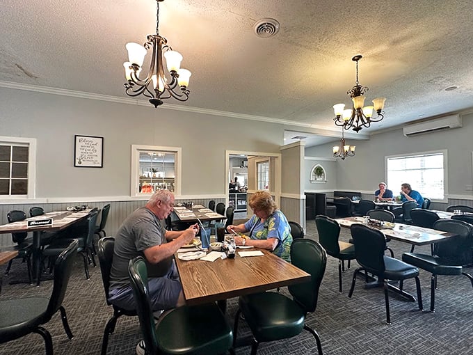 The dining room's simple elegance lets you focus on what matters—the food. Those chandeliers have witnessed countless "mmm" moments.