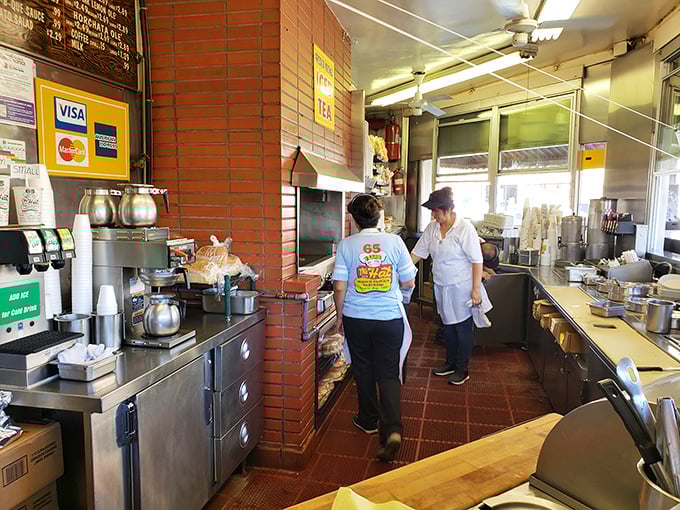 Behind the counter, culinary magic happens in an efficient dance. This no-frills kitchen has produced more happiness than most five-star establishments.