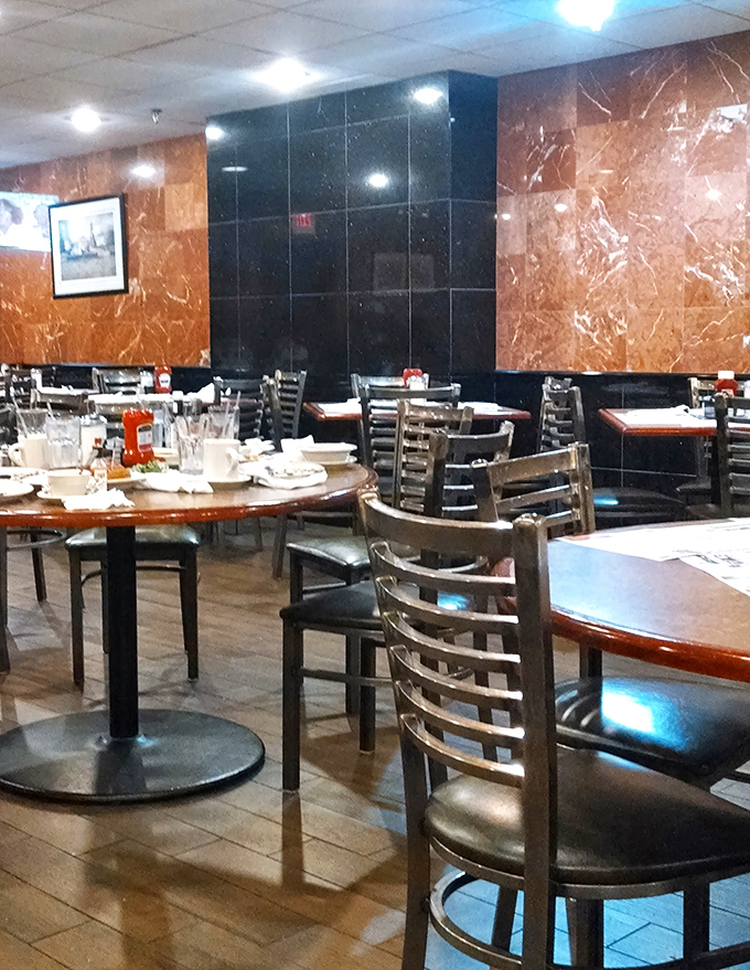 Marble walls and comfortable seating create that perfect diner atmosphere—fancy enough to impress but casual enough that you can show up in sweatpants.