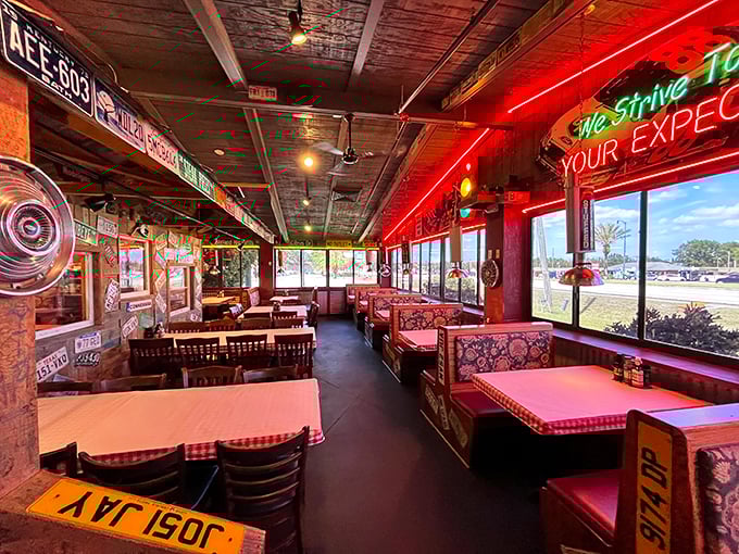 Red neon casts its glow over checkered tablecloths and license plate-adorned walls. This isn't ambiance—it's a time machine to when restaurants had personality.