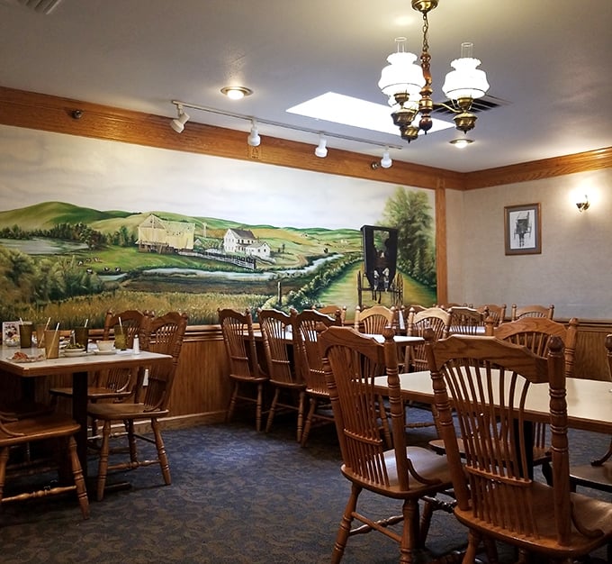 Step inside where pastoral murals and wooden chairs create comfort food's perfect natural habitat.