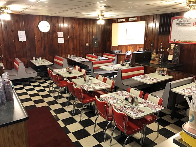 Step into dining nostalgia where red vinyl booths and checkered floors create pure Americana magic.