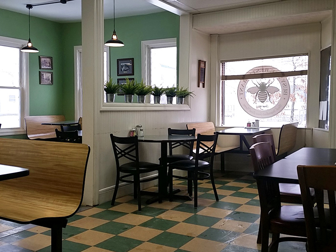 Classic diner charm with mint green walls and checkerboard floors—the kind of place where calories don't count and diet plans happily surrender. 