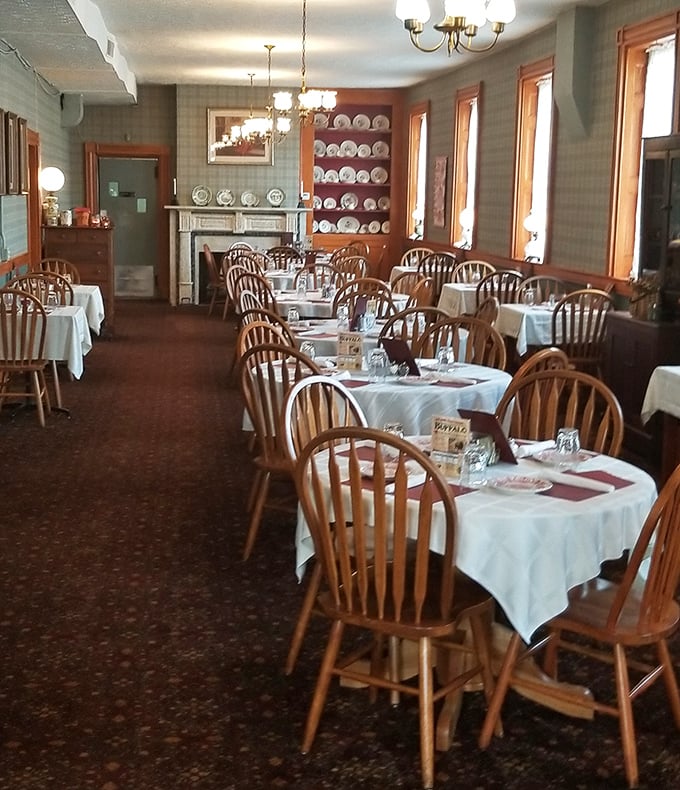 Windsor chairs and white tablecloths create the kind of ambiance that makes jeans feel underdressed.