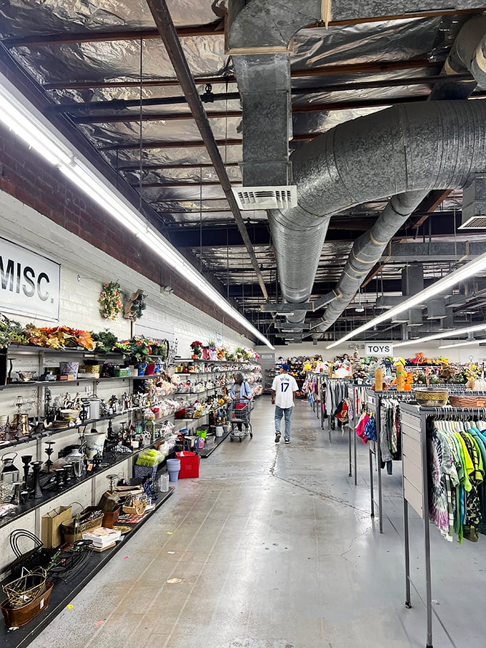 Endless aisles stretch toward retail infinity, where miscellaneous treasures meet organized chaos under industrial ductwork.