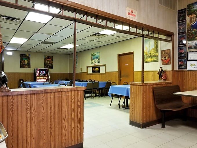 Step inside and time stands still. Wood paneling, blue tablecloths, and fluorescent lighting create the perfect stage where pizza, not décor, plays the starring role.
