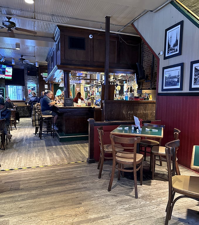 Inside, worn wooden floors and red wainscoting create that perfect "been here forever" vibe where strangers become friends and regulars hold court.