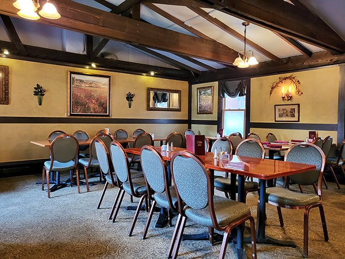 Exposed wooden beams frame this dining room like a painting, where comfortable chairs invite you to settle in for the long haul of culinary delight.
