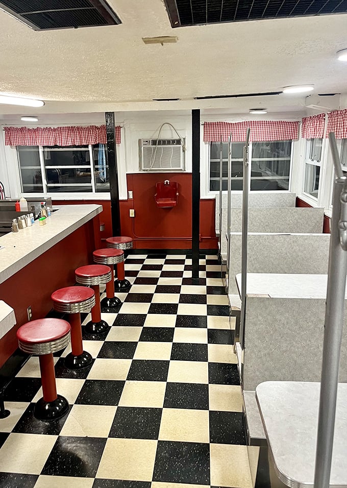 The classic diner checkerboard floor and red counter stools aren't retro by design—they're authentic by survival, outlasting countless food trends.