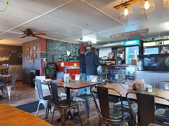 Inside, the "We Don't Serve Mean People" sign isn't just decor—it's a philosophy that pairs perfectly with metal chairs, wooden tables, and chalkboard menus.
